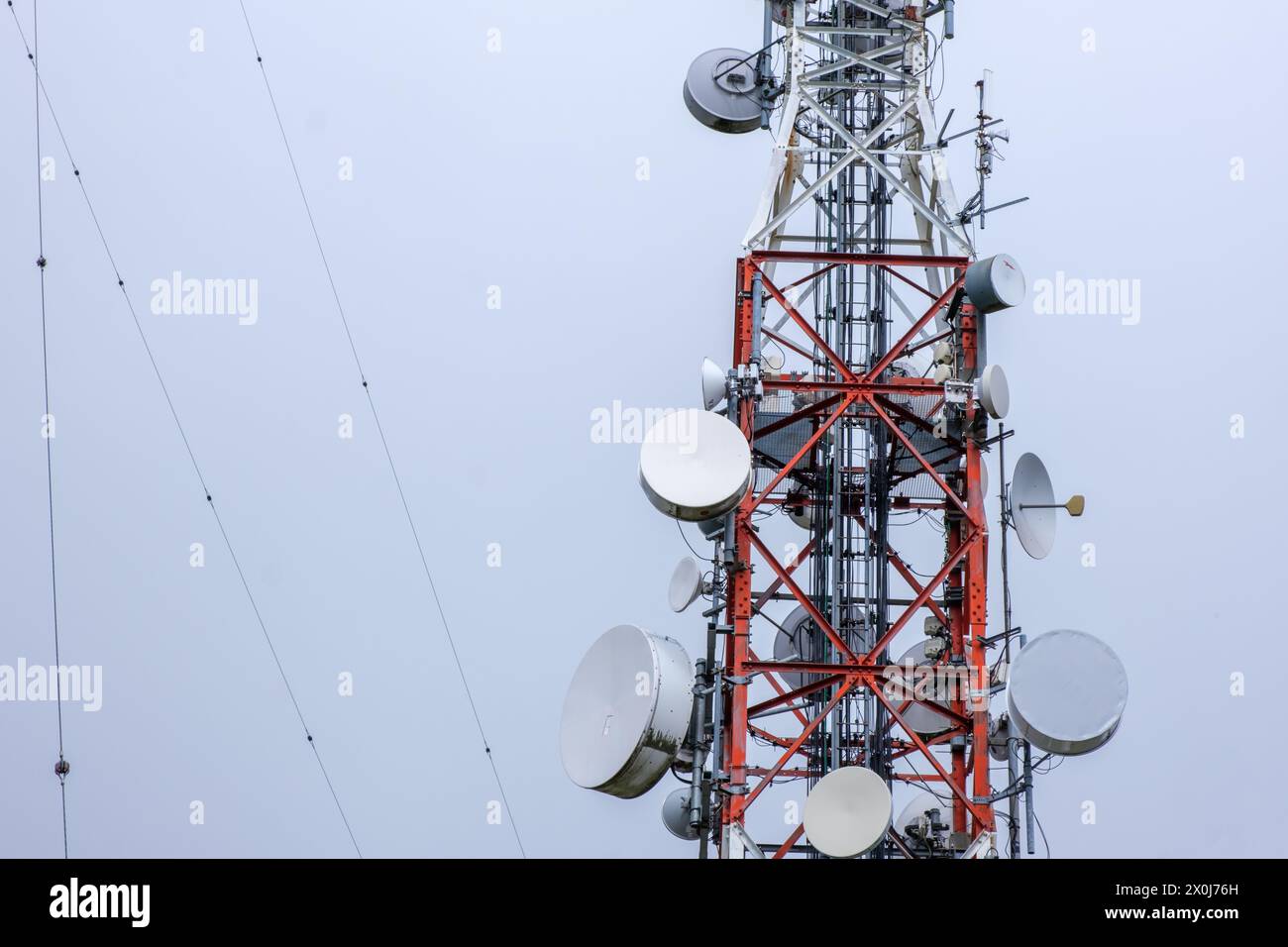 A tall tower stands prominently in the landscape, featuring a multitude ...