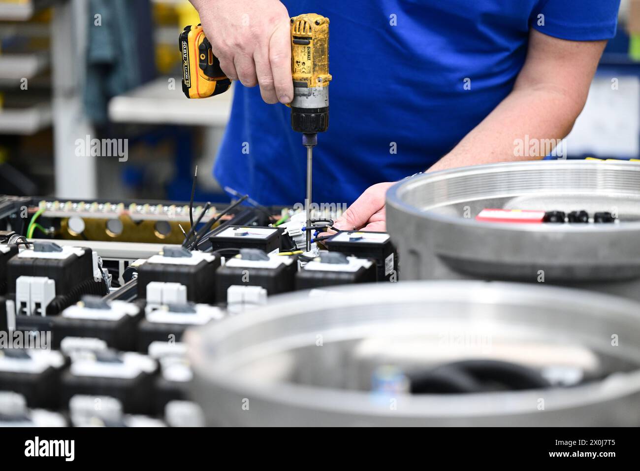 09 April 2024, Baden-Württemberg, Waldenburg: A worker manufactures an ...