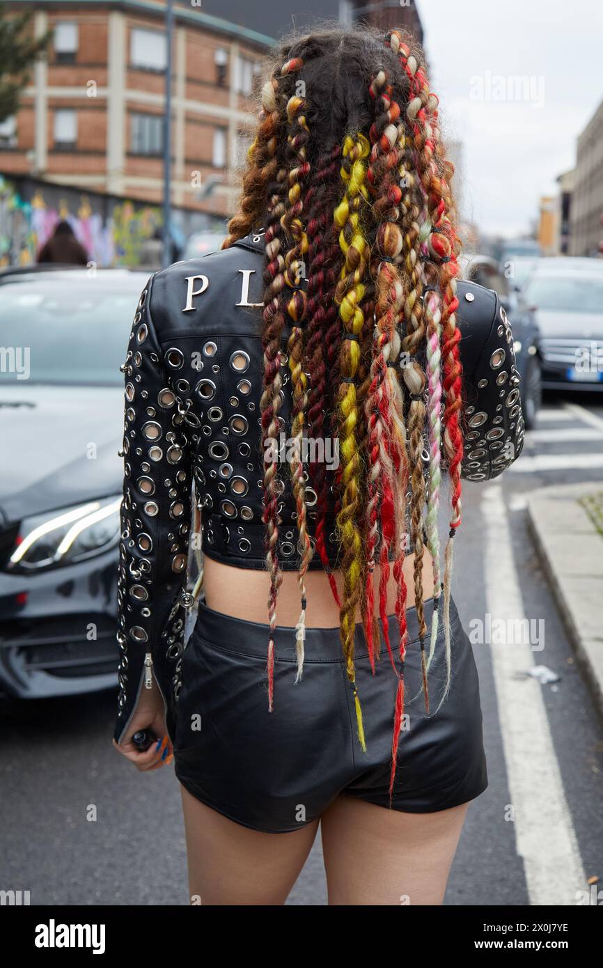 MILAN, ITALY - FEBRUARY 23 , 2024: Woman colorful braids and Philipp ...