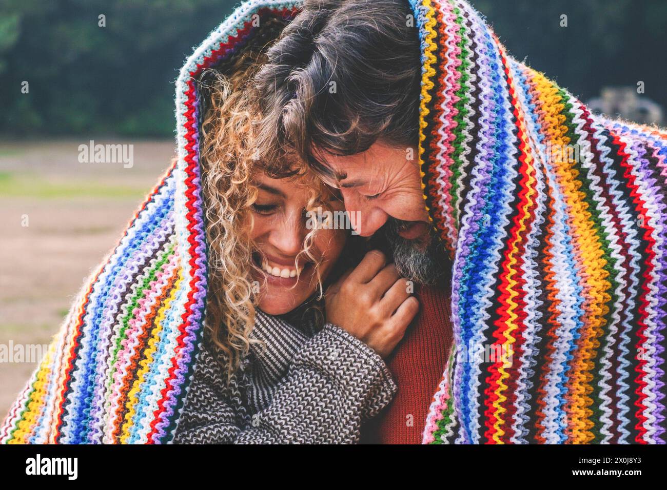 Intimate funny and happy moments with adult couple in outdoor leisure ...