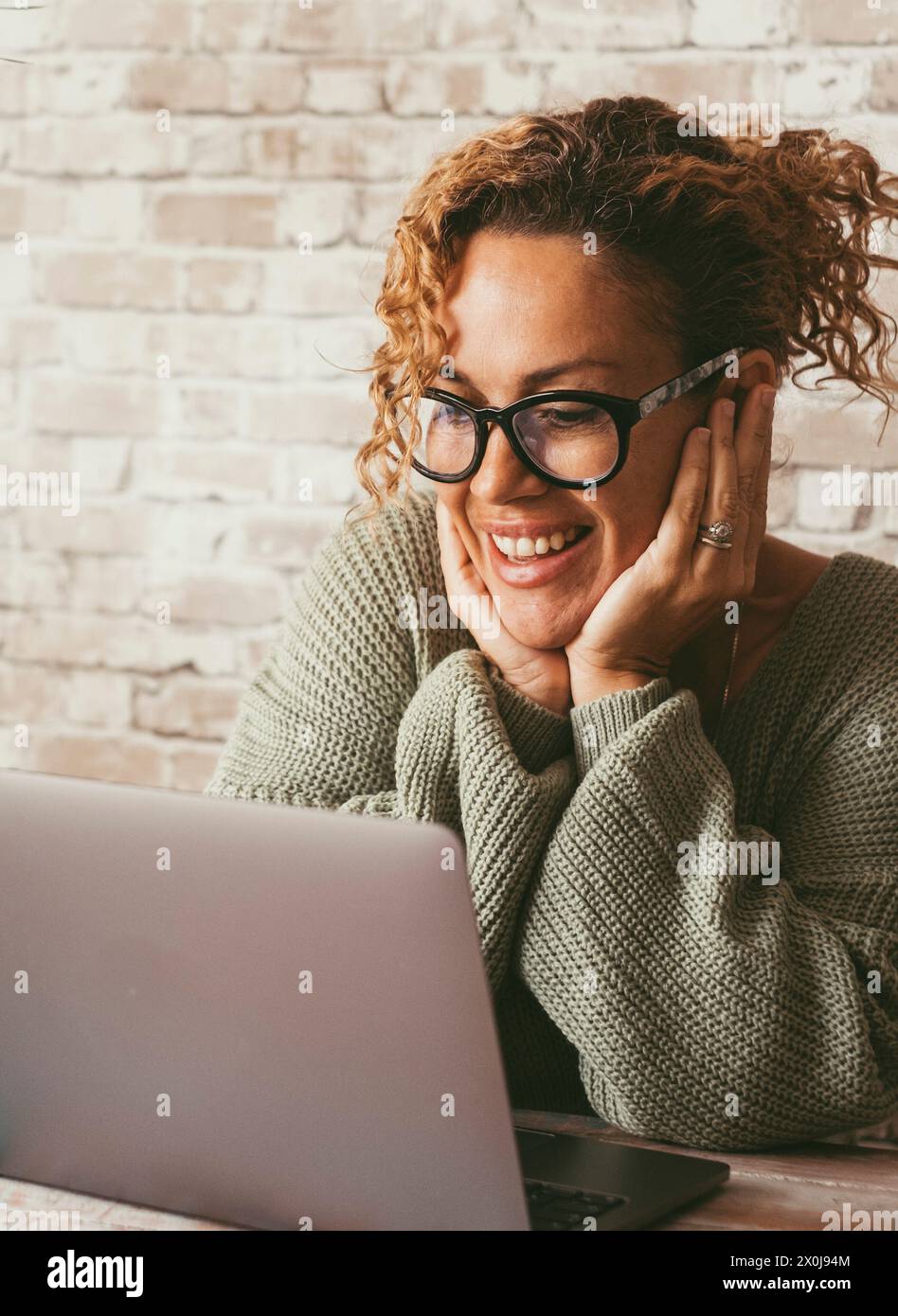 Cheerful attractive woman doing video call conference with computer ...