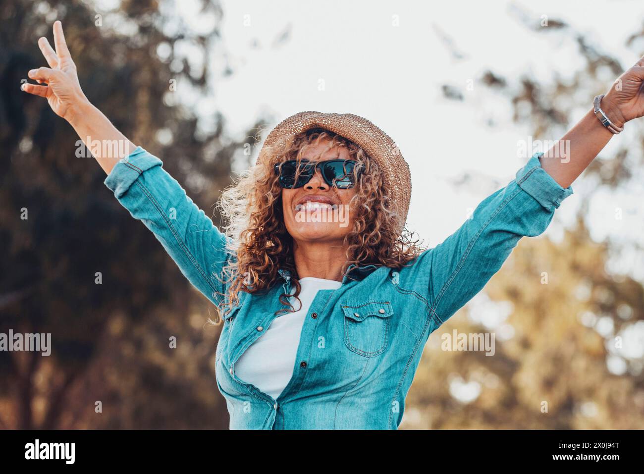 Overjoyed people happy woman raising her arms with victory gesture and ...