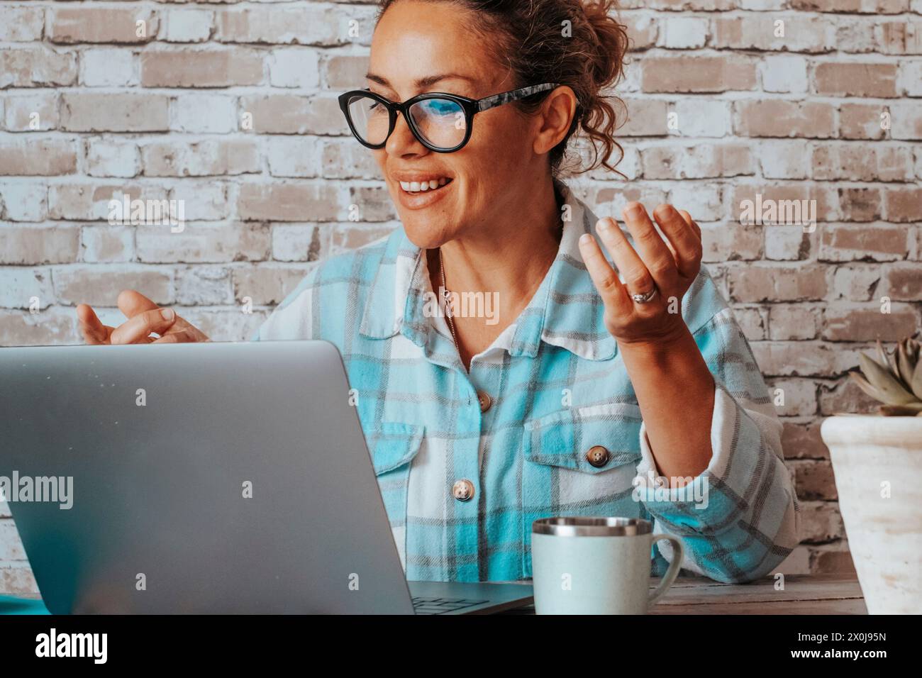 Hipter young woman talking in video call conference onine on laptop ...