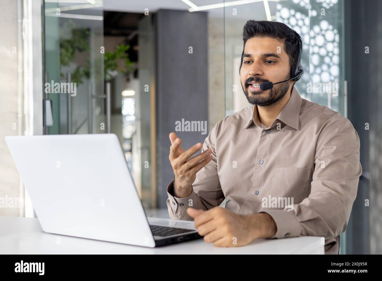 A young professional man engaging in customer service using a headset ...