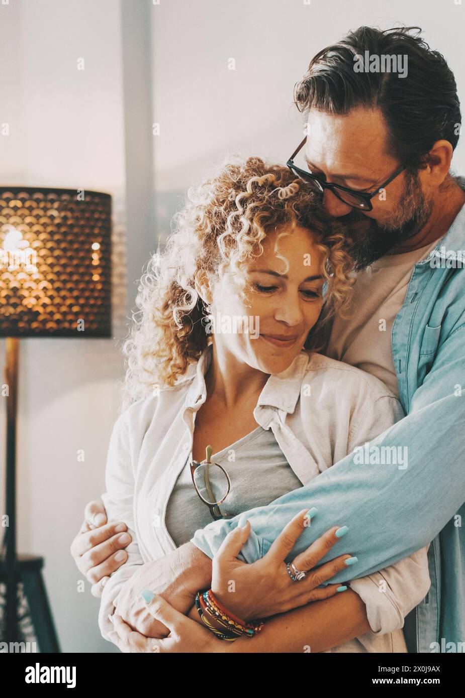 Romantic love and relationship with young couple hugging at home ...