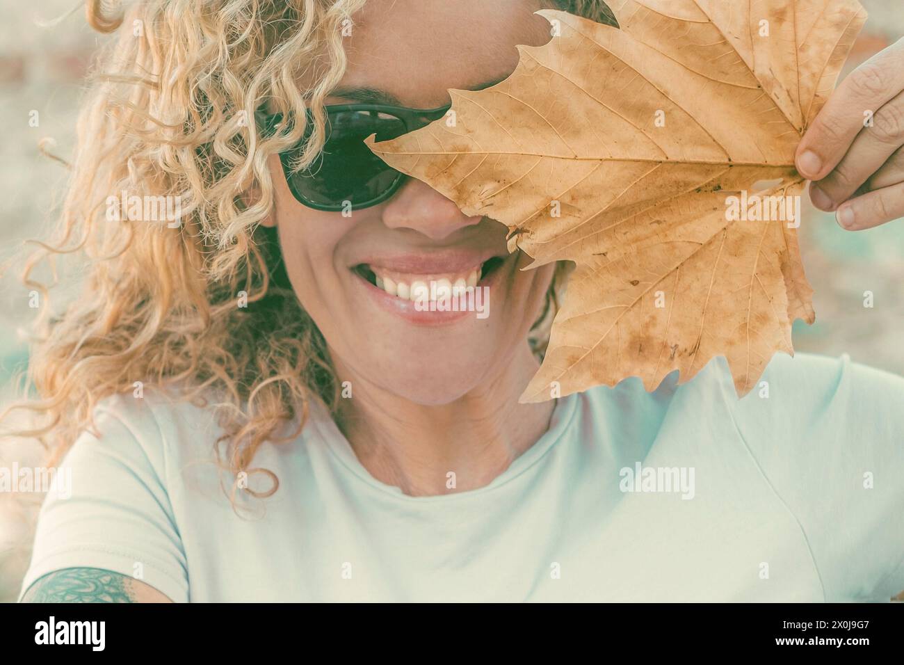 Playful happy woman portrait smiling and hidden half face with big ...