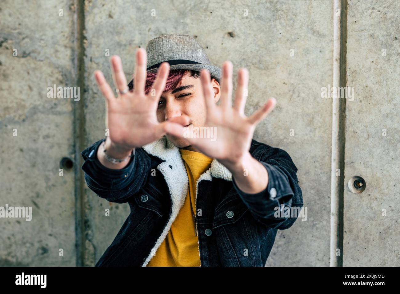 One young teenager guy doing stop sign with palm of hands and smile ...
