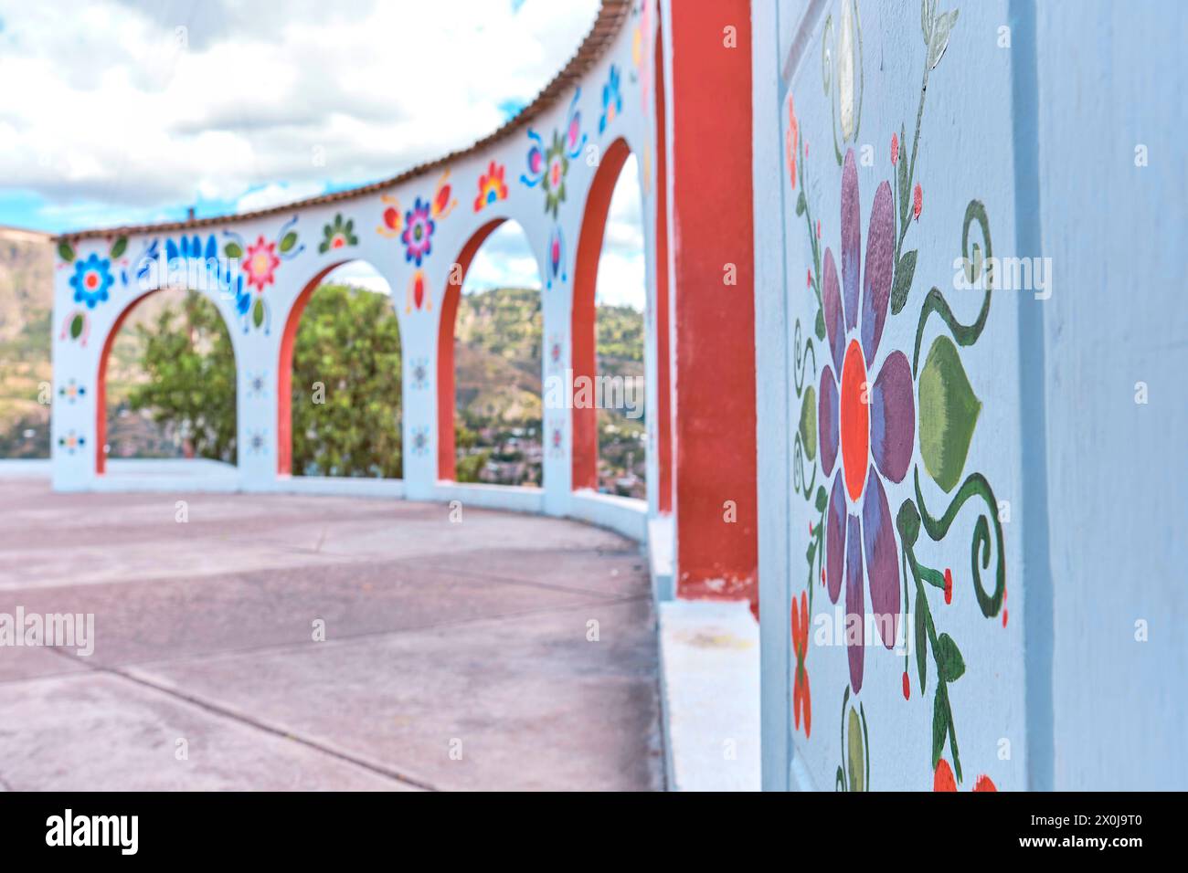 A long white archway with trees on either side, arch of Acuchimay ...