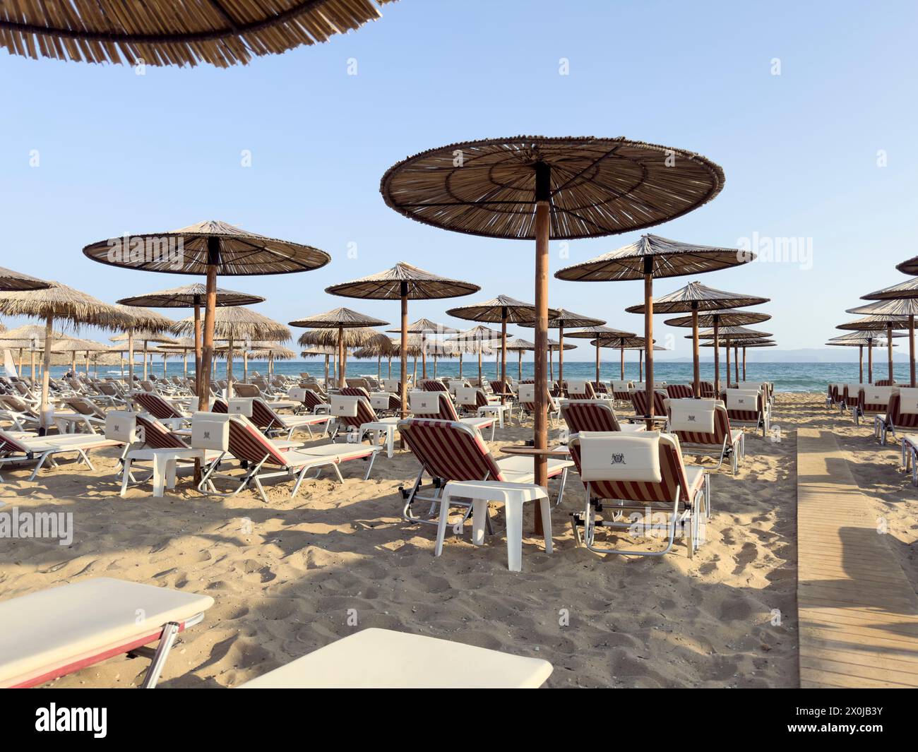 Empty sun loungers in the early morning on the beach of Gouves on the ...
