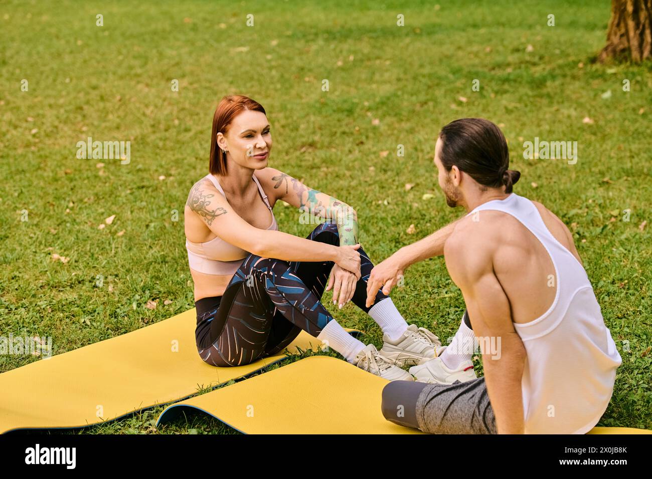 A woman, dressed in sportswear, engaging in a workout session guided by ...
