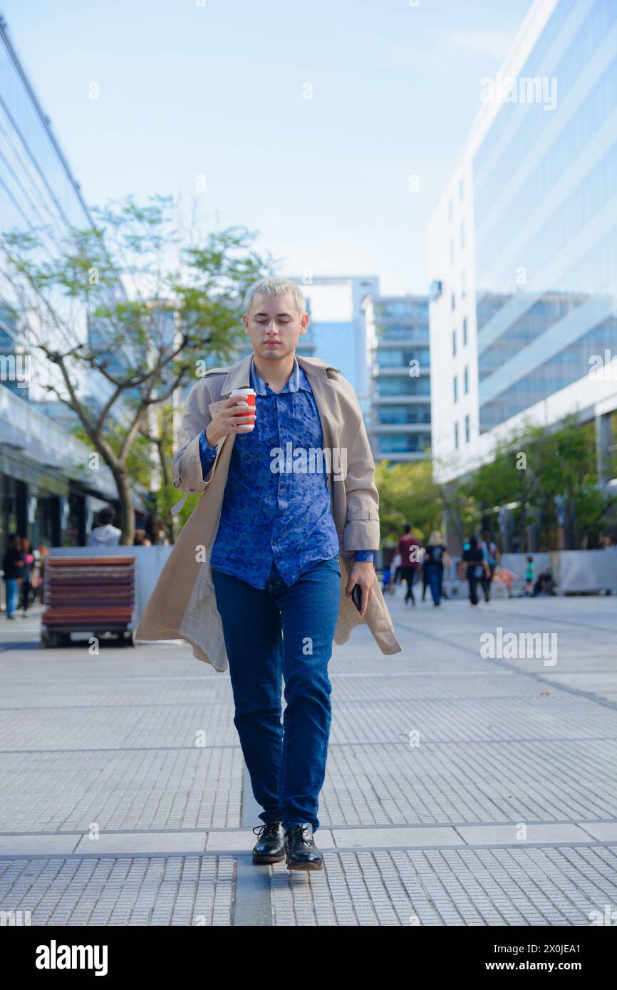 Front view and vertical image of young entrepreneurial man walking ...