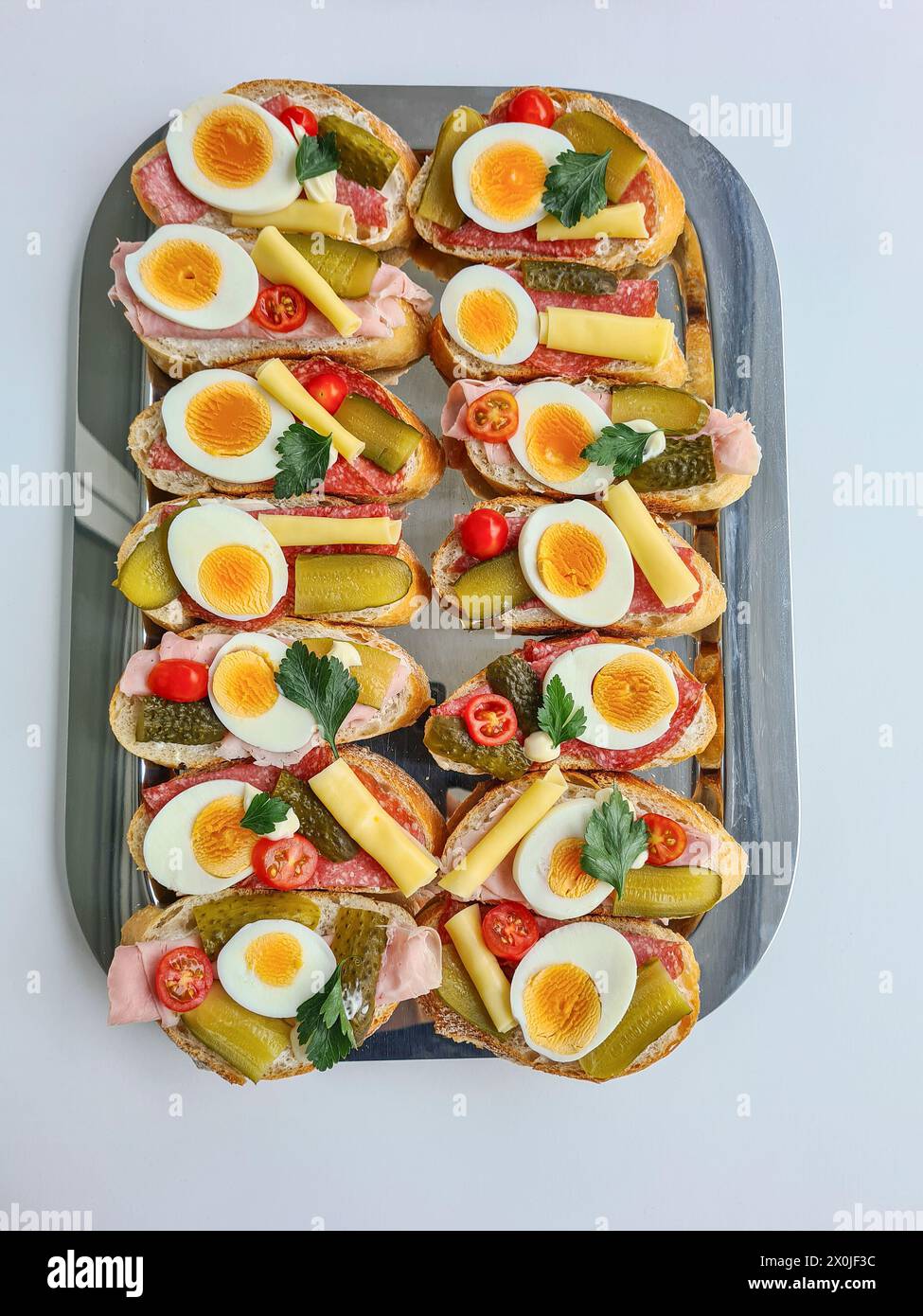 Egg slices and cooked ham on bread as an appetizer hi-res stock ...