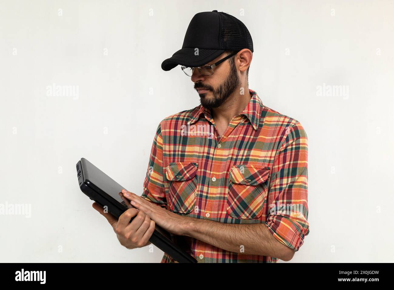 Latin American man with his laptop computer is a programmer and ...