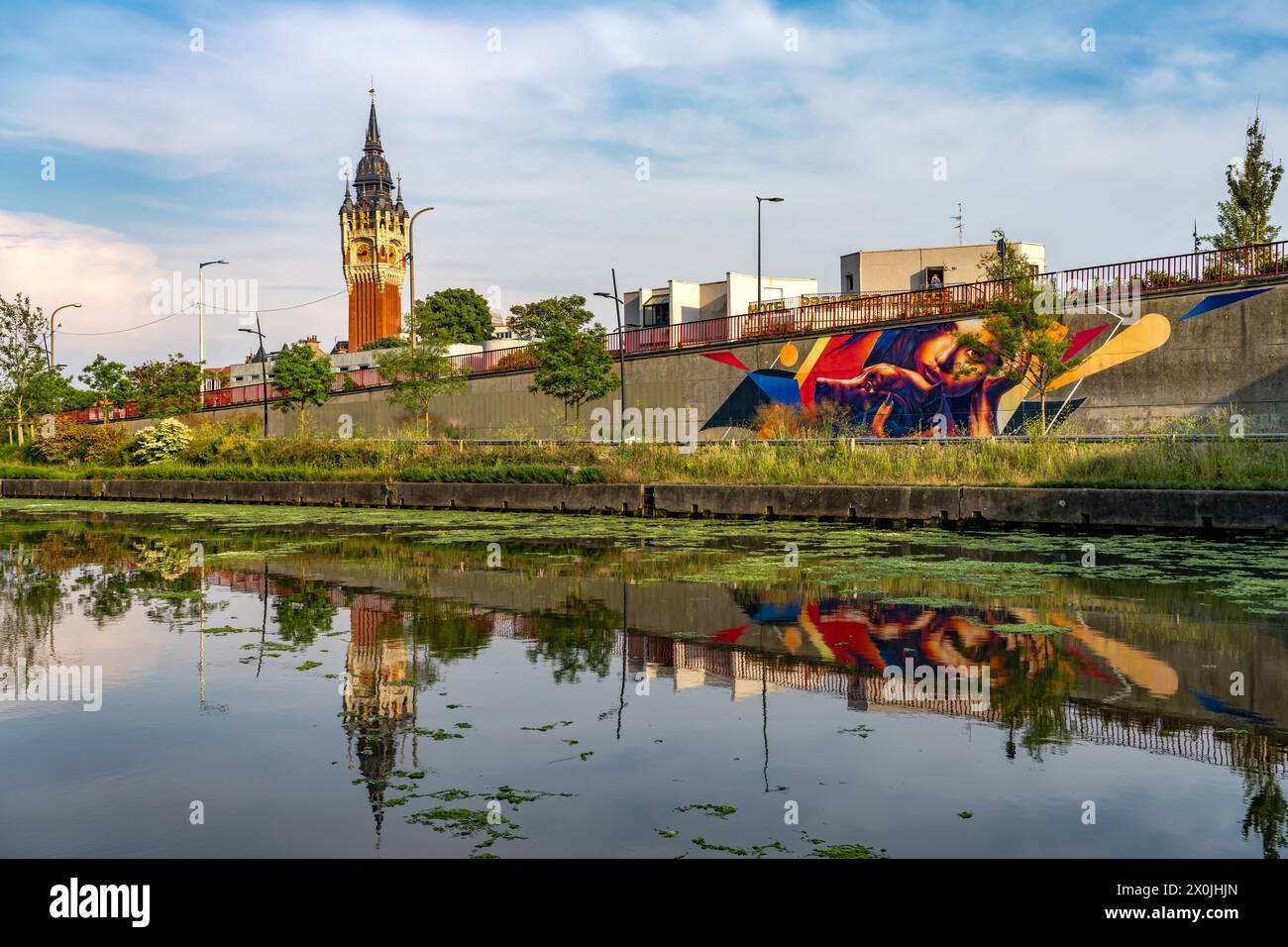 Graffiti on the canal and the tower of the town hall in Calais, France ...