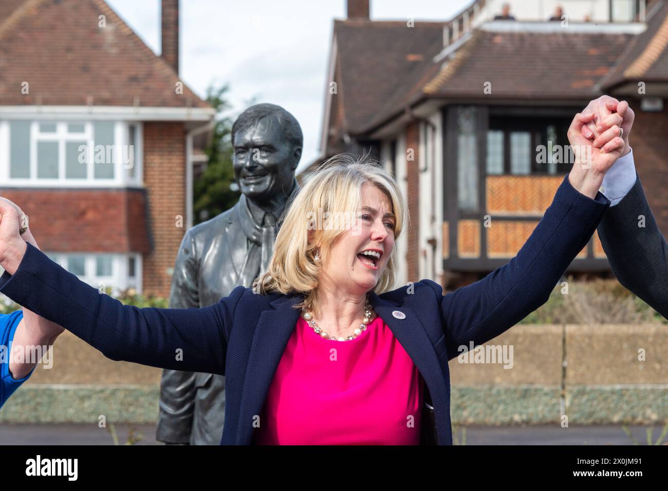 Anna Firth MP joining in with singing at an event to unveil a statue ...