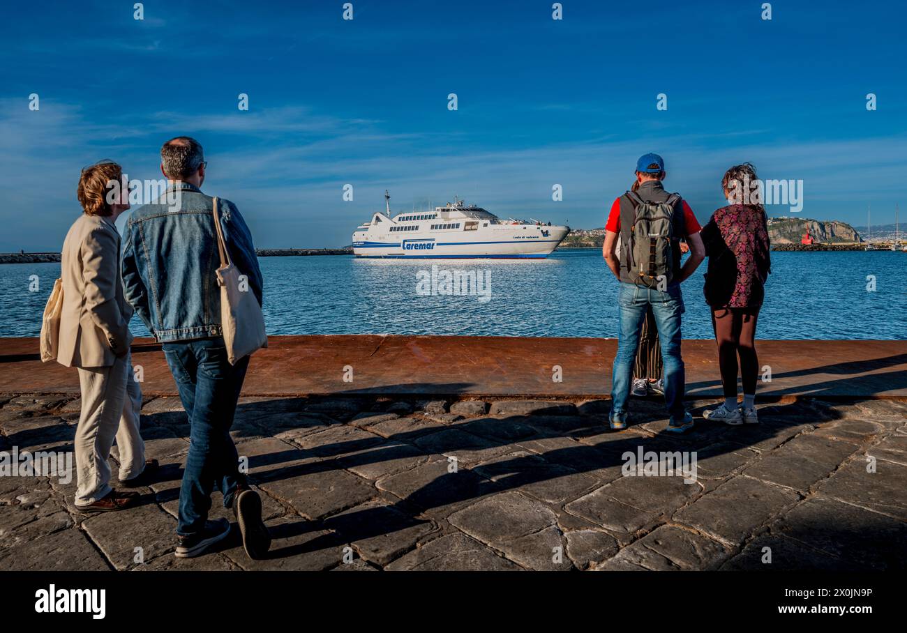 People watching the Caremar ferry Isola di Vulcano arriving in Procida ...