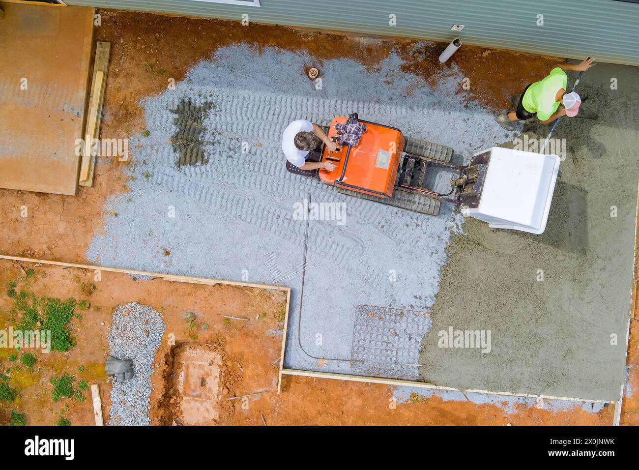 Construction of foundation involves pouring of wet cement into ...