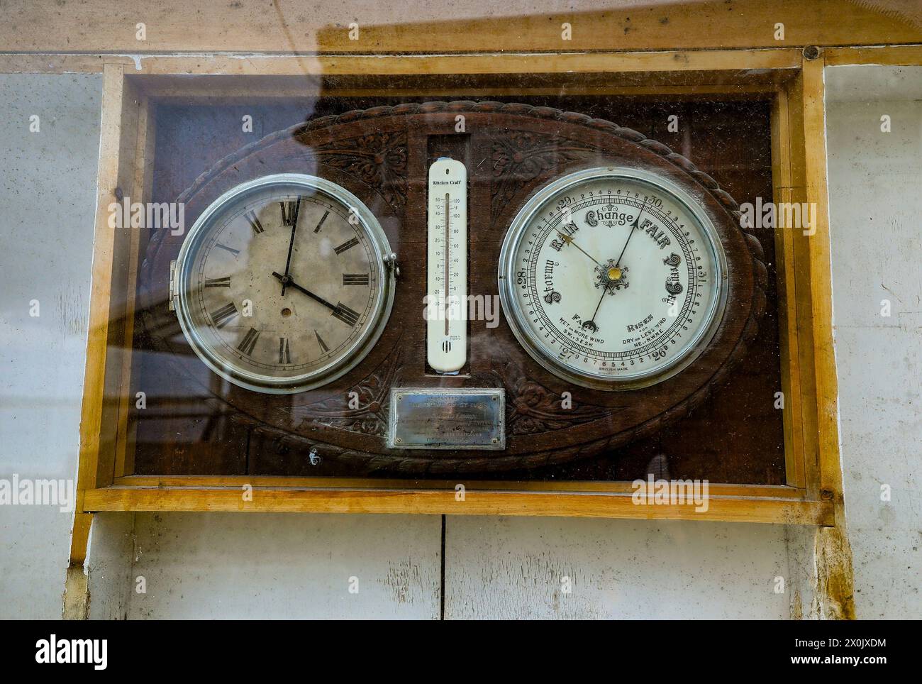 A clock, thermometer and a barometer on the harbour at St. Ives ...