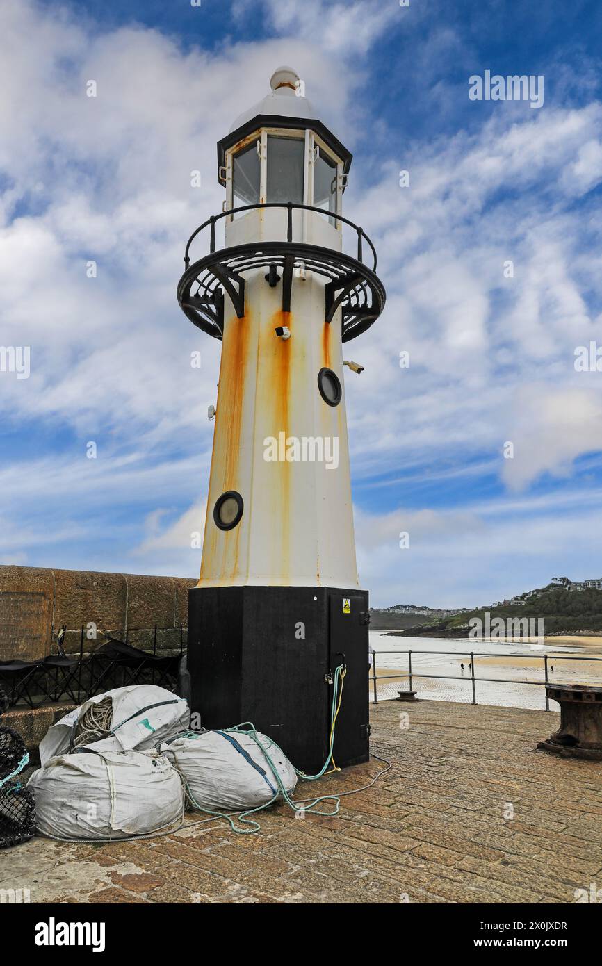 A lighthouse at the end of the pier at St. Ives Harbour, St. Ives ...