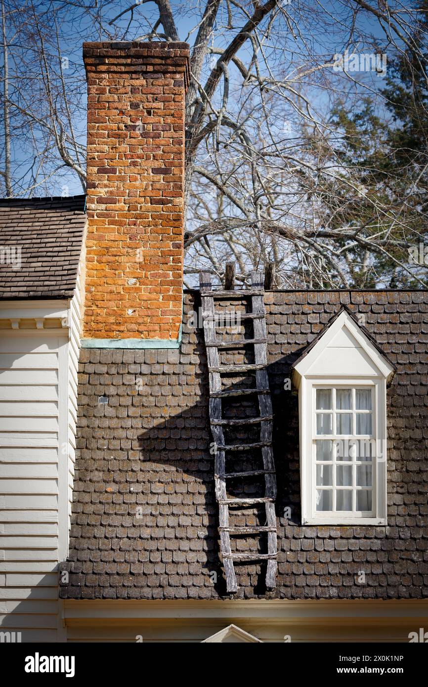 A ladder attached to a roof on a building at Colonial Williamsburg ...