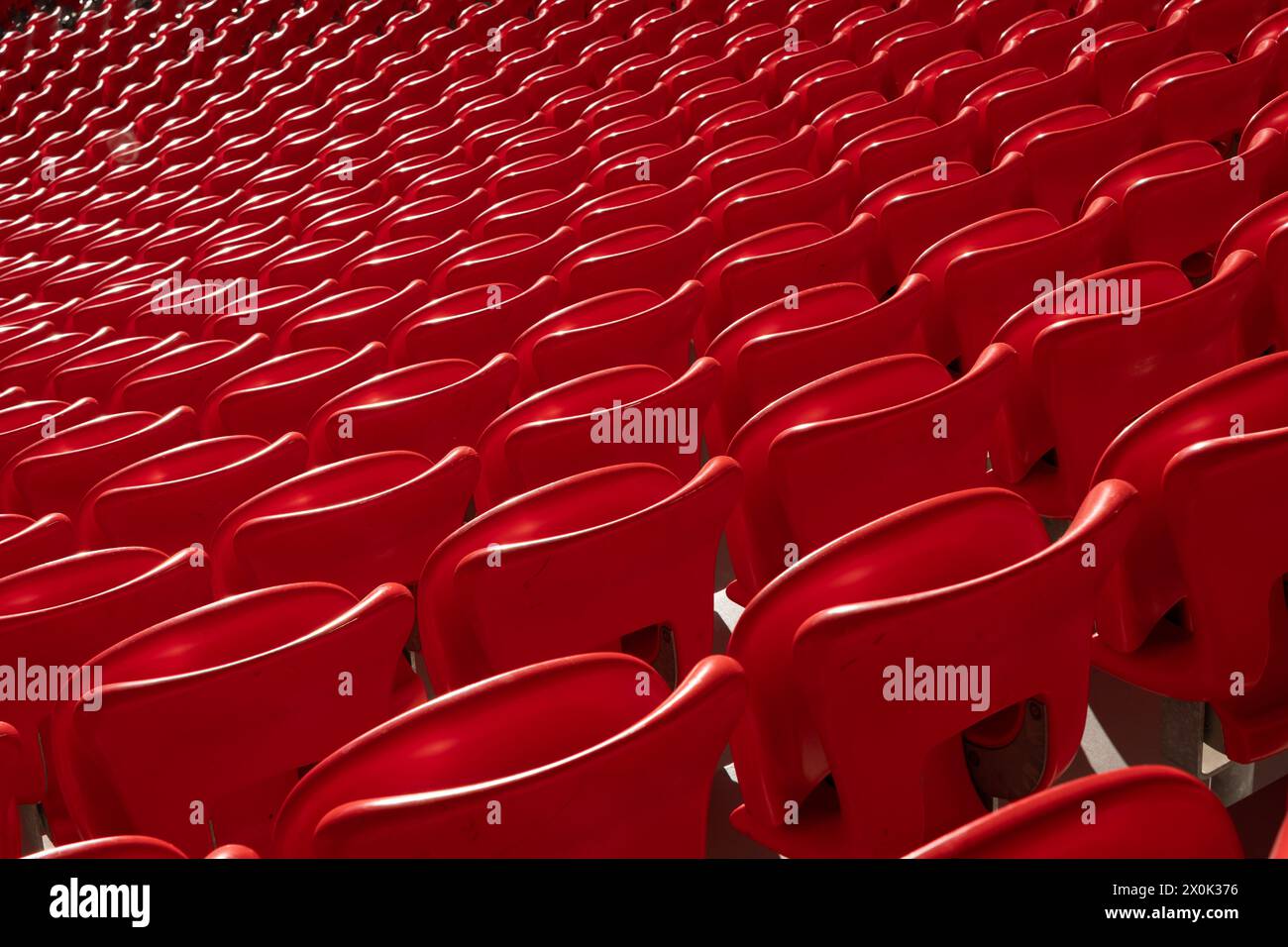Symmetry pattern of red seats in a football stadium Stock Photo - Alamy