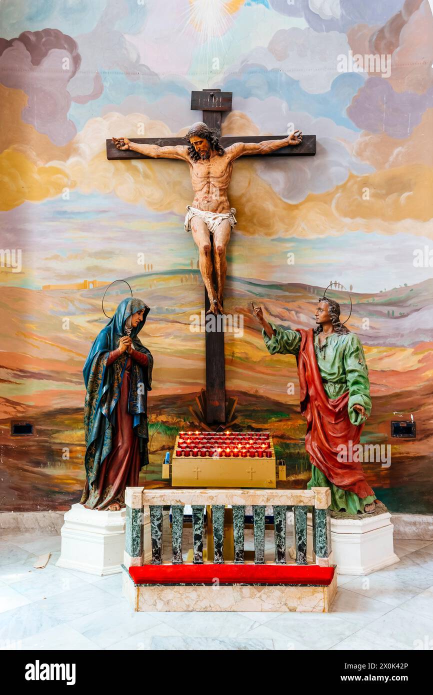 Christ on the Cross, flanked by Our Lady and St. John. The background ...