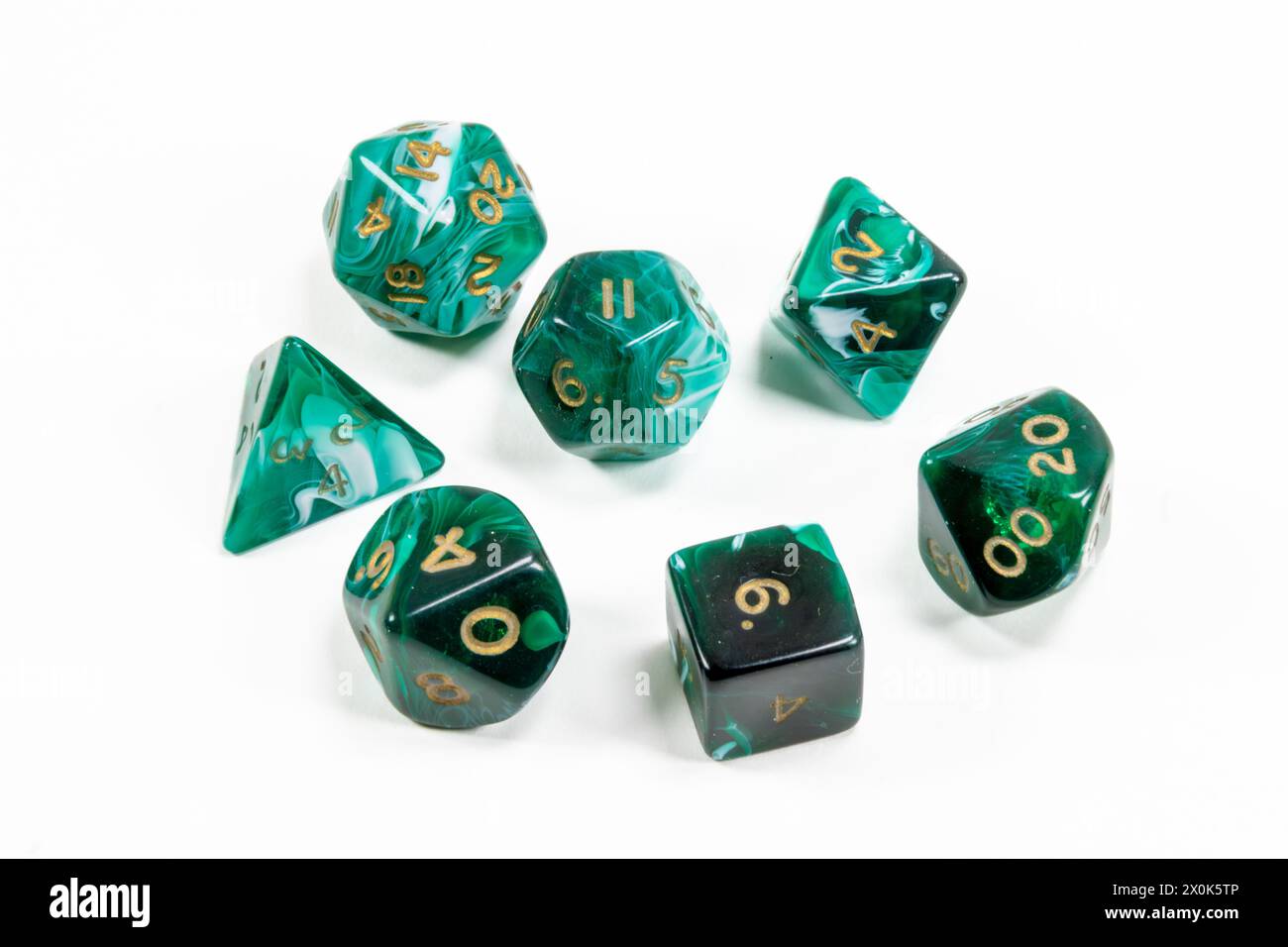A green set of role playing dice on a white background Stock Photo - Alamy