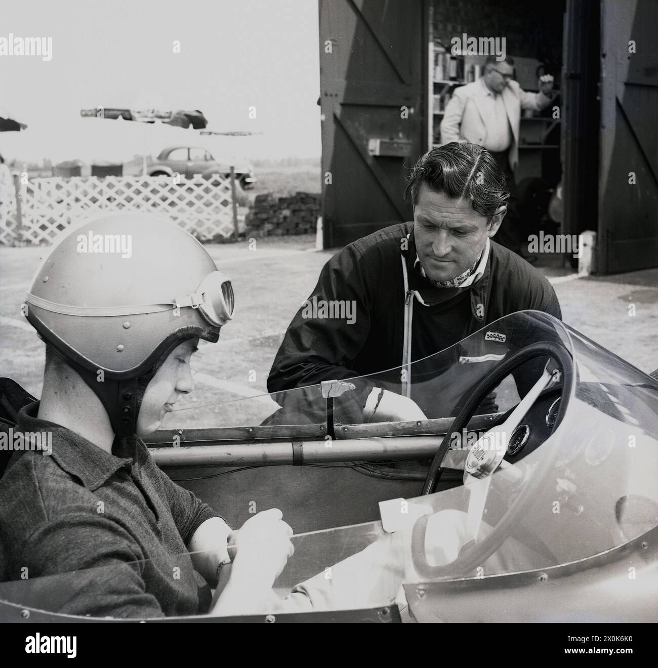 1962, historical, an instructor with a young racing driver sitting in a ...