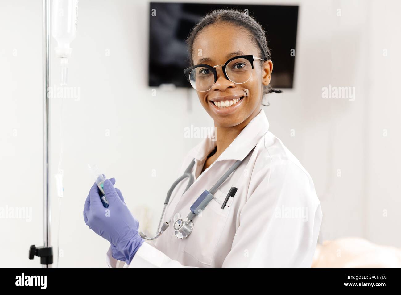 A female doctor wearing a white coat and blue gloves, ready to assist ...