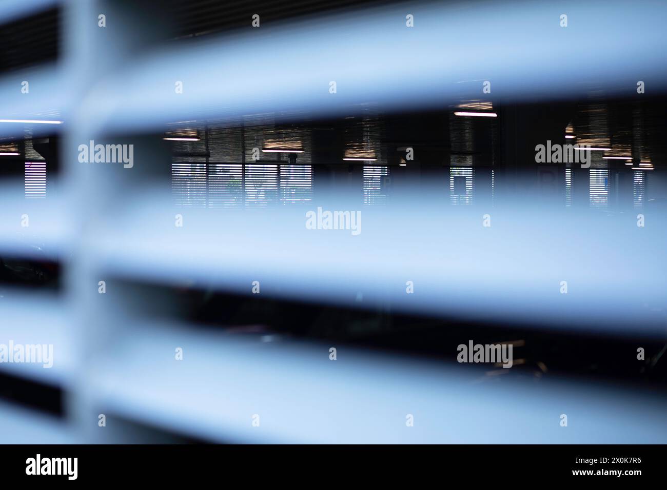 Metal barriers, car park fence, in the background blurred lights inside ...