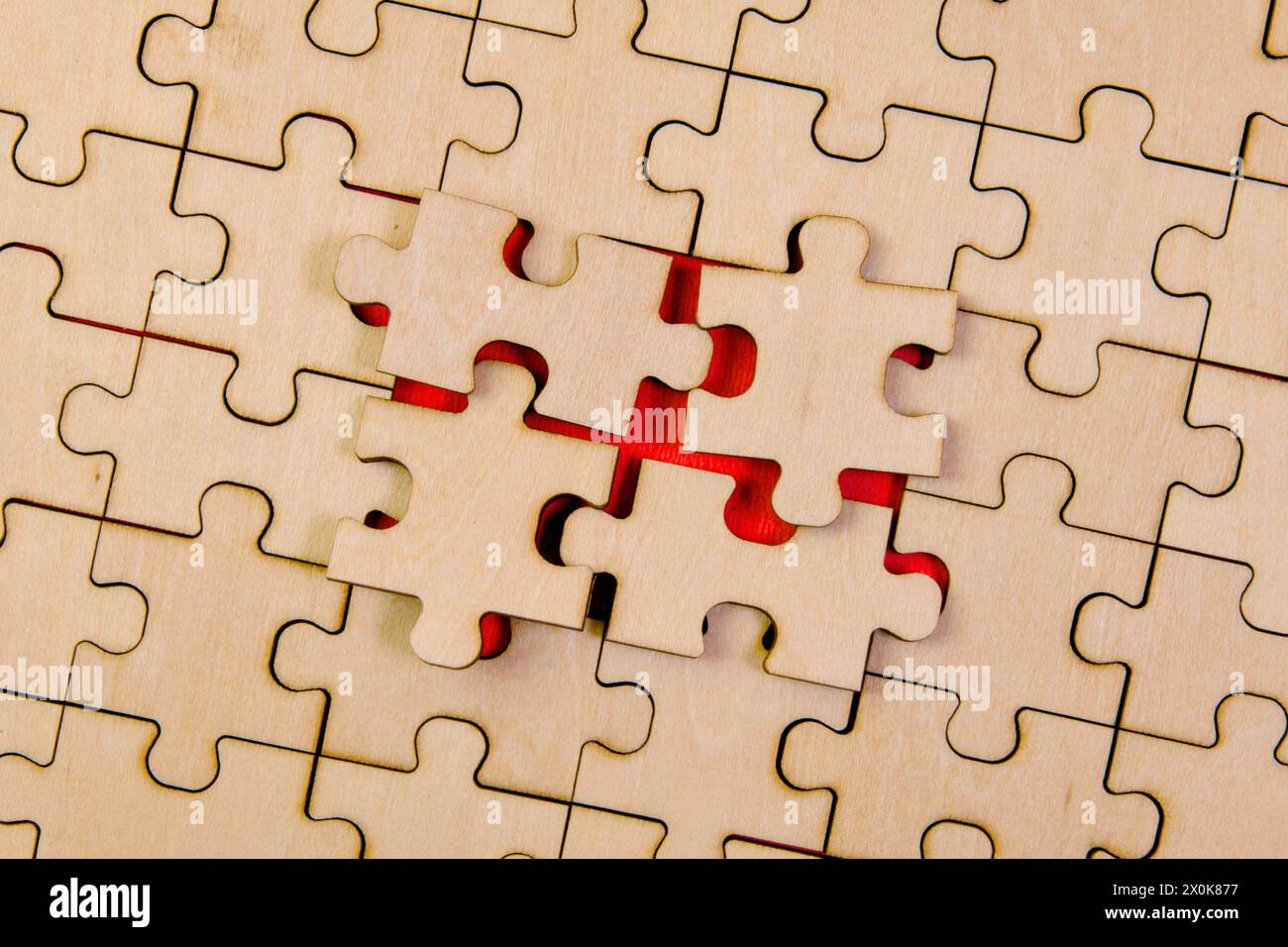 Close-up view of wooden jigsaw puzzle pieces fitting together ...