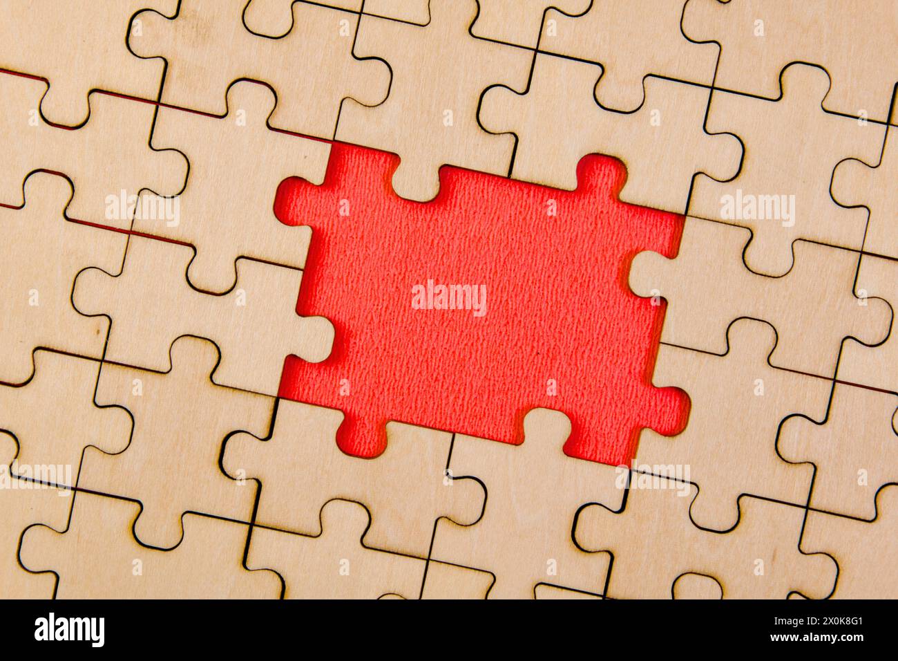 A close-up view of a jigsaw puzzle with a single piece missing ...