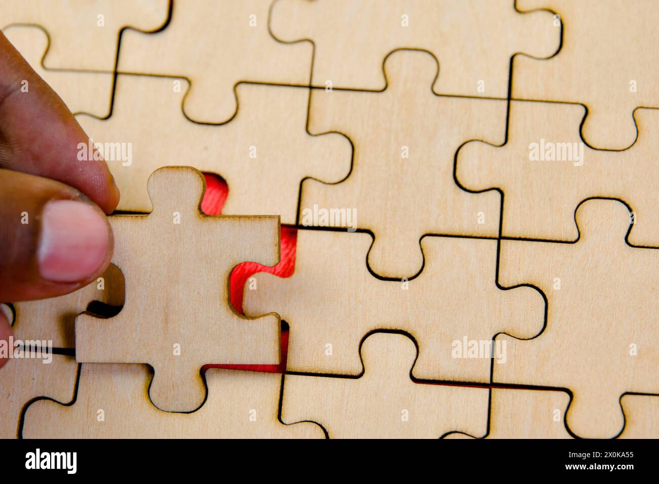 connect the final pieces of a jigsaw puzzle, symbolizing teamwork ...