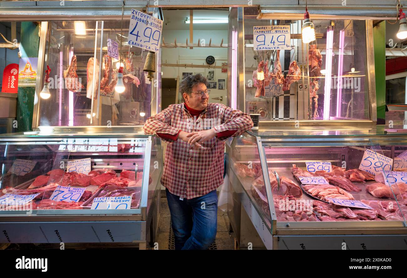 Butcher, meat trader posing proudly in front of his market stall ...