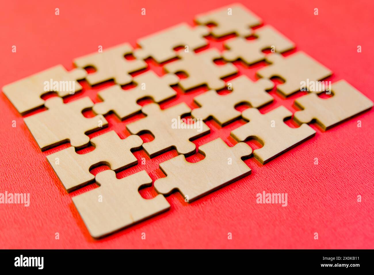 Close-up view of wooden puzzle pieces fitting together seamlessly on a ...