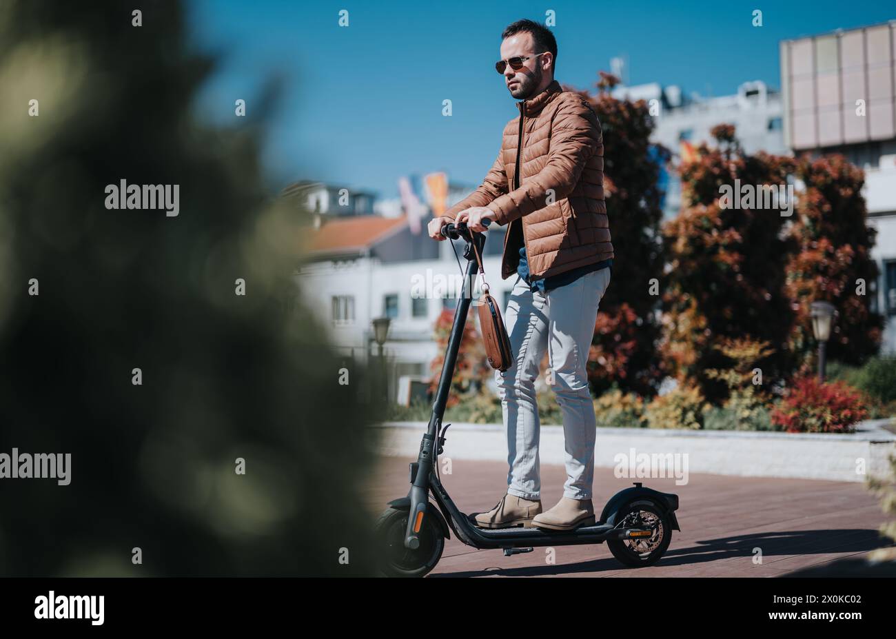 Outdoor business meeting with entrepreneurs using electric scooters for ...