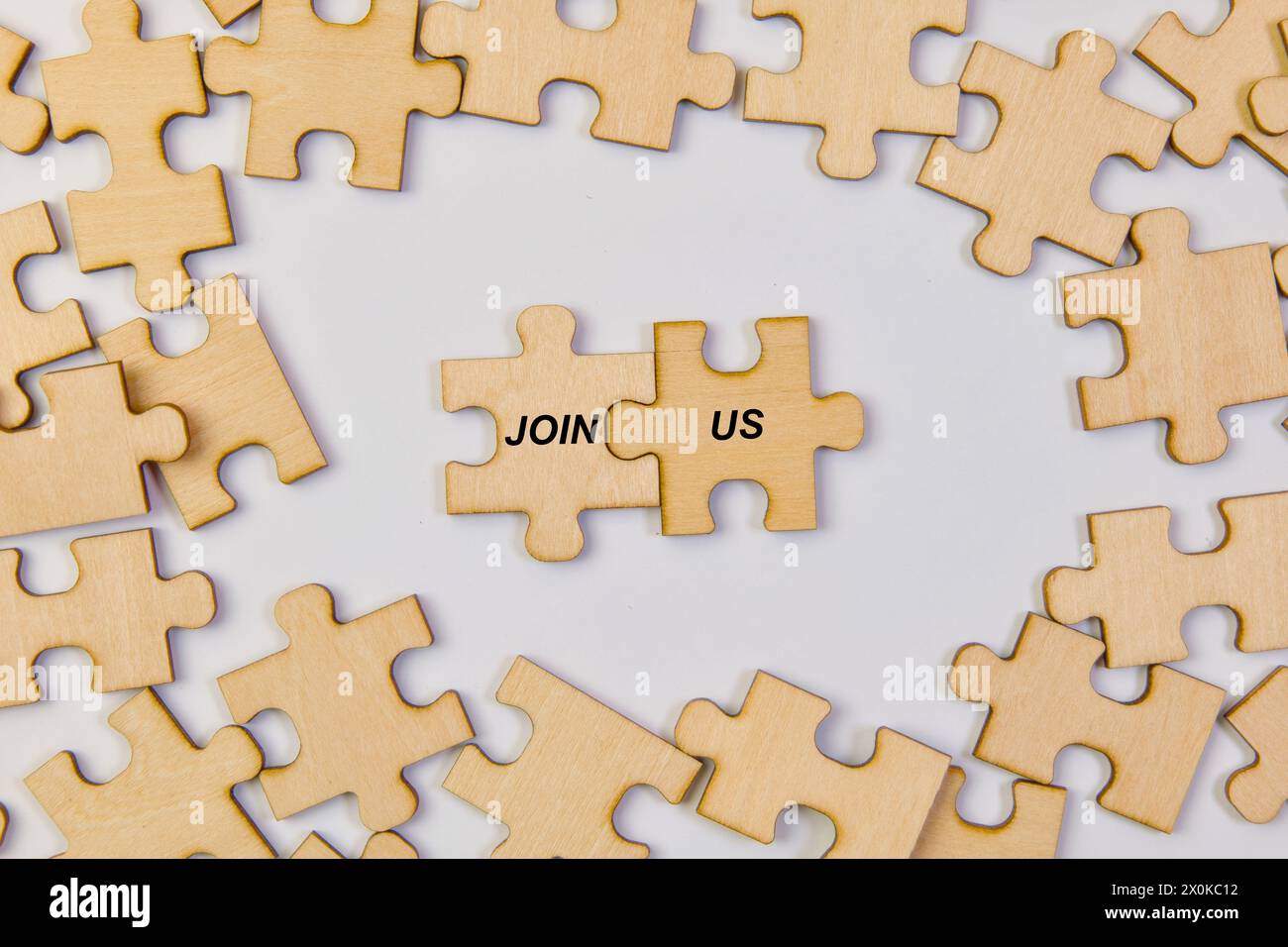 Interlocking jigsaw puzzle pieces forming the phrase JOIN US ...
