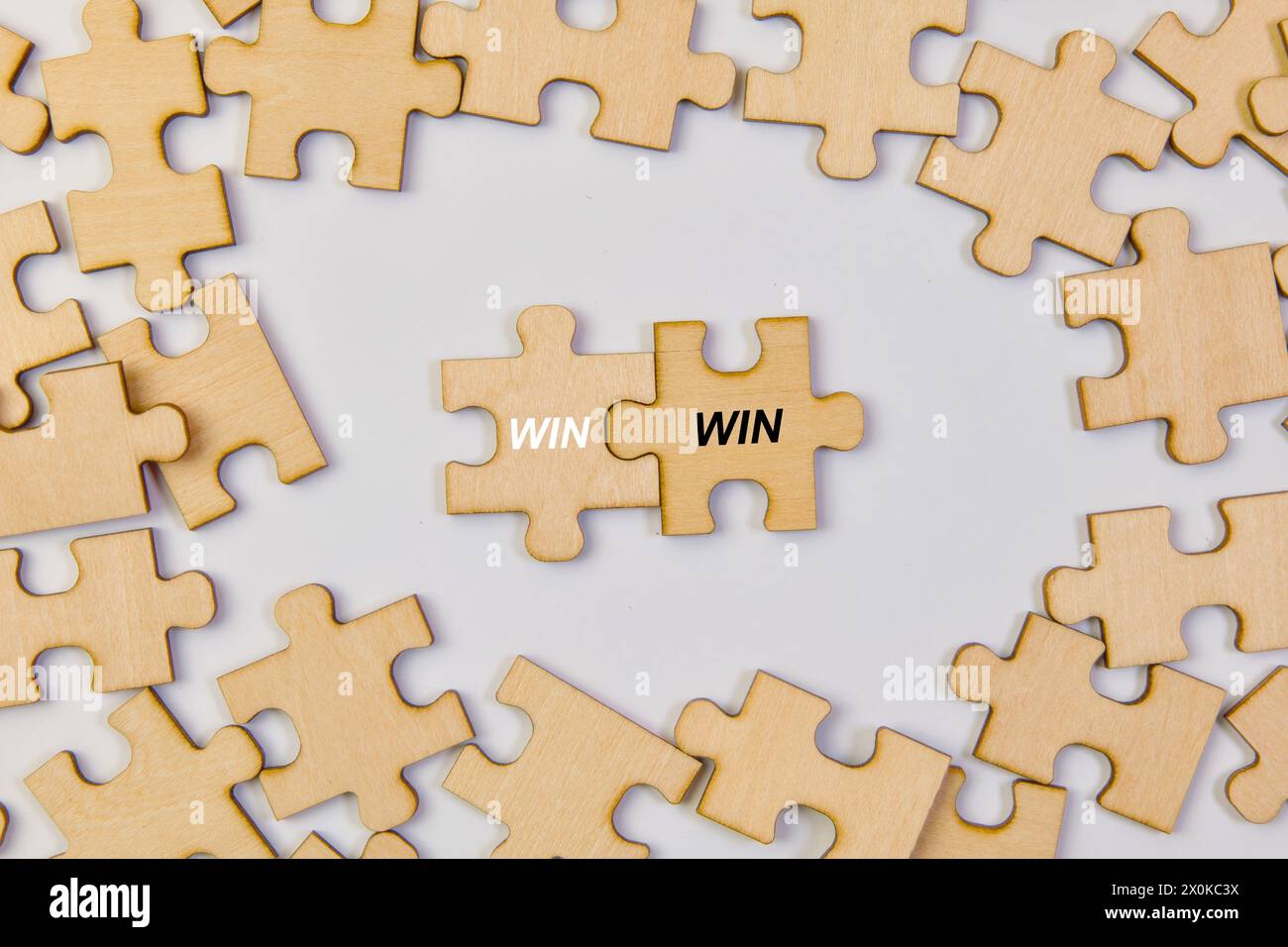 Image of jigsaw puzzle pieces coming together to form the word "WIN ...