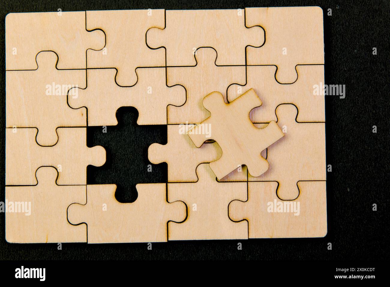 Scattered jigsaw puzzle pieces on a black background symbolize a ... Scattered jigsaw puzzle pieces on a black background symbolize a ...