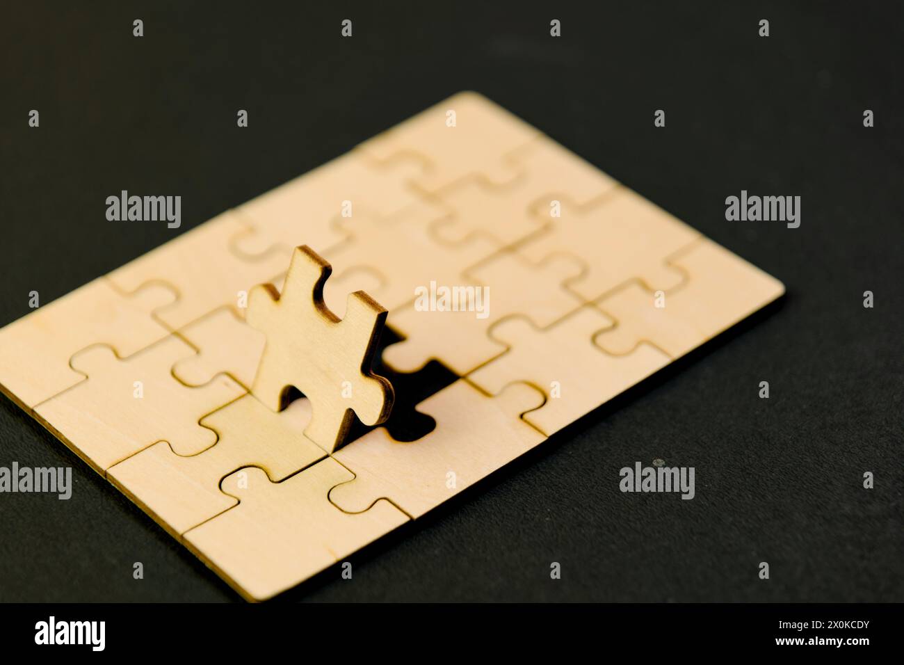 A close-up of an unfinished jigsaw puzzle with a single missing piece ...