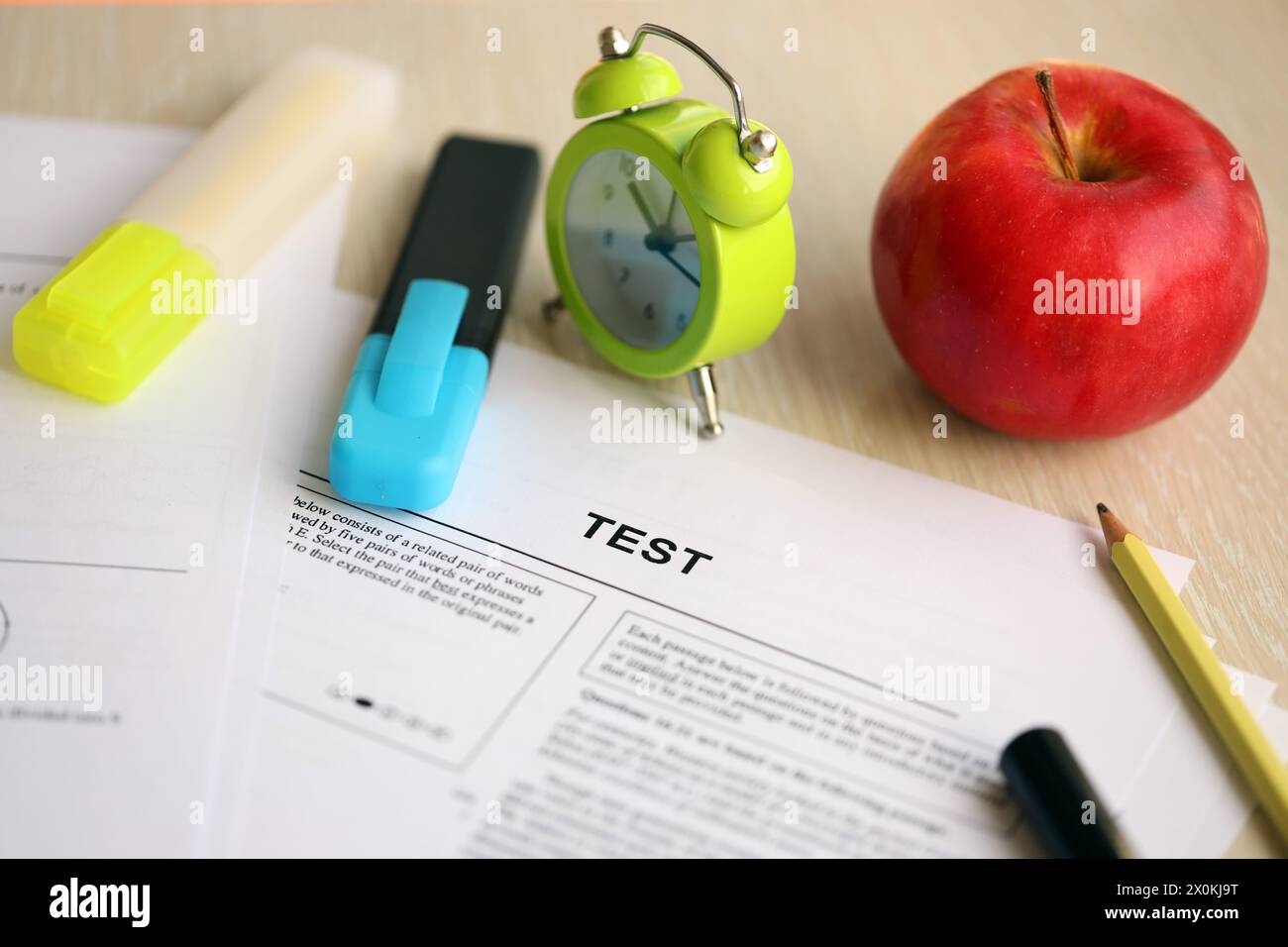 Blank educational test for students lies on table in classroom with pen ...