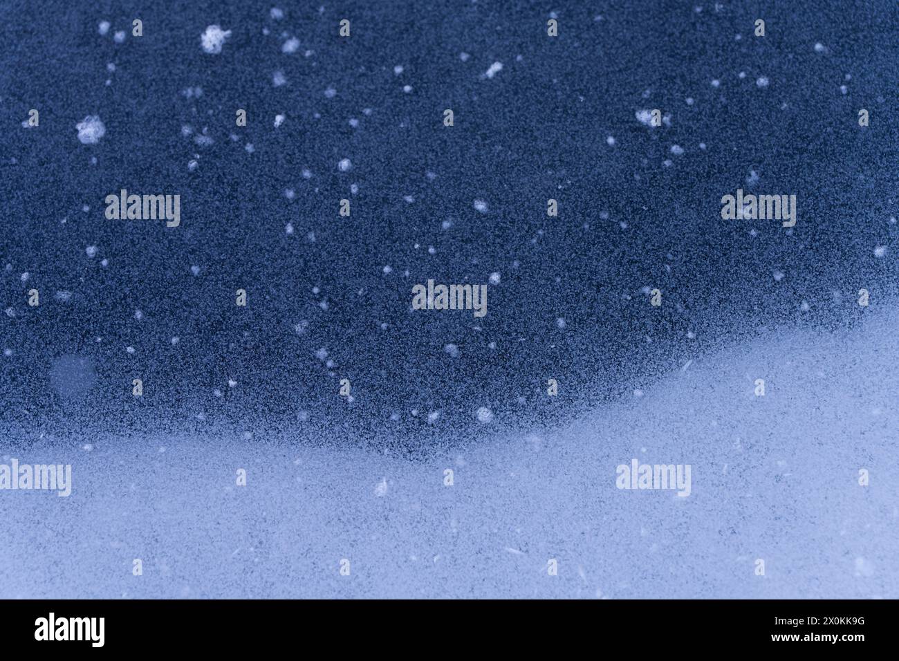 Ice layer on a lake, air bubbles trapped in the ice, close-up, Germany ...