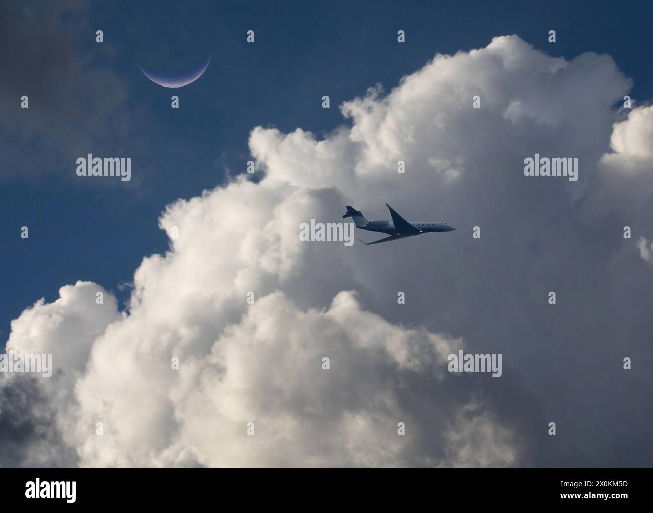 A corporate jet flies near storm clouds shortly after takeoff with a ...