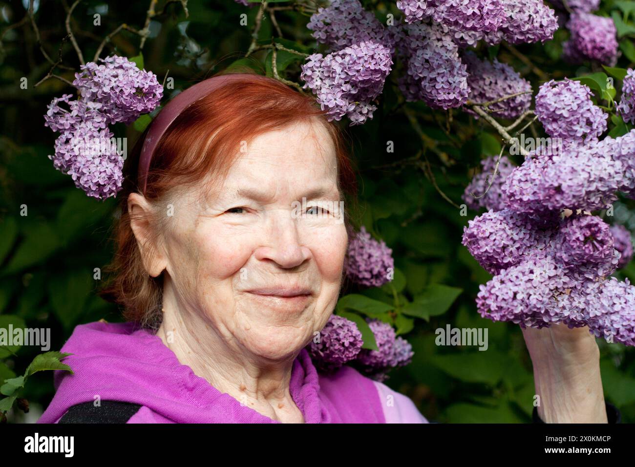 Outdoor close-up portrait of old woman. Beautiful elderly woman smiling ...