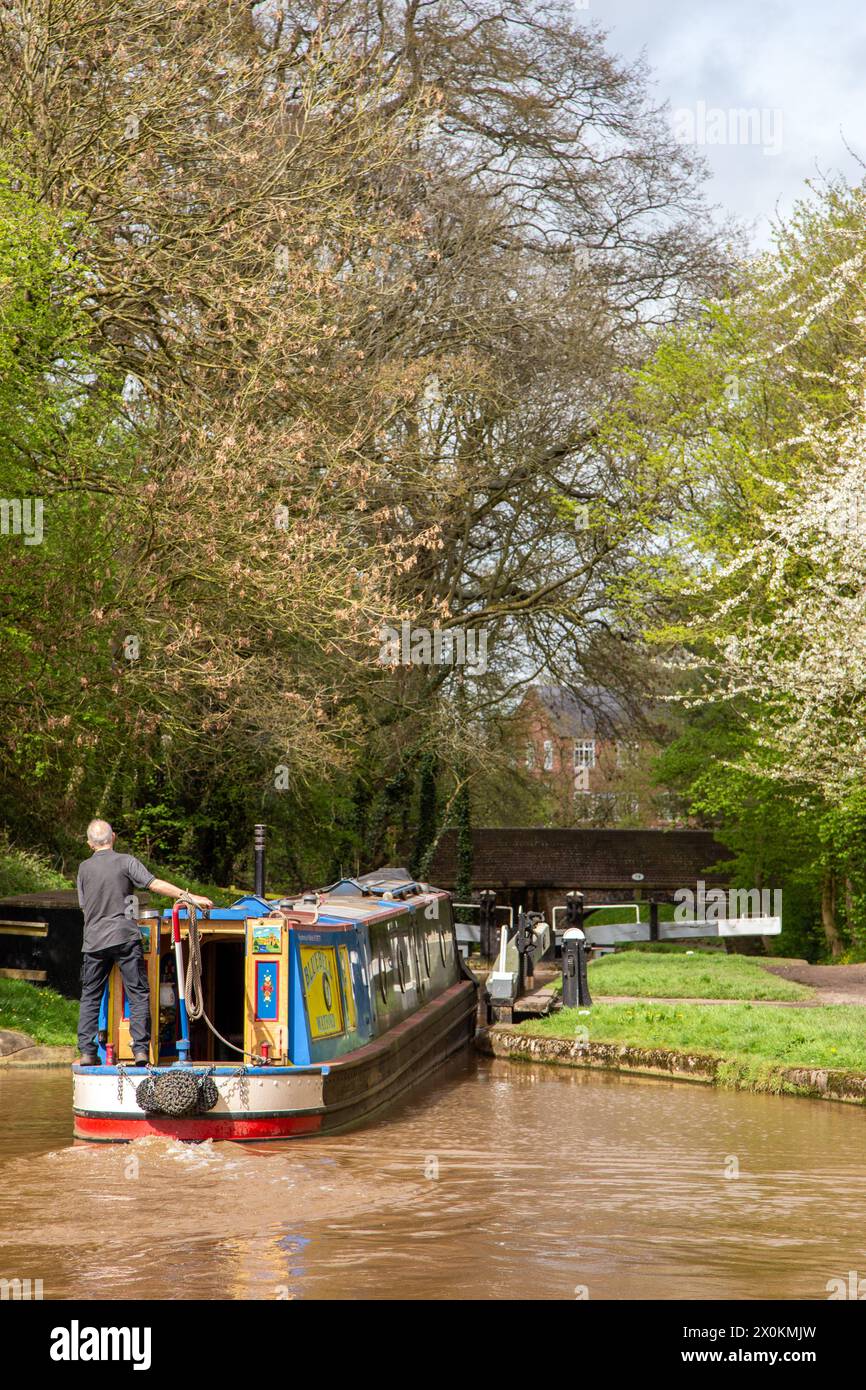 Man taking a canal narrowboat single handed through locks on the ...