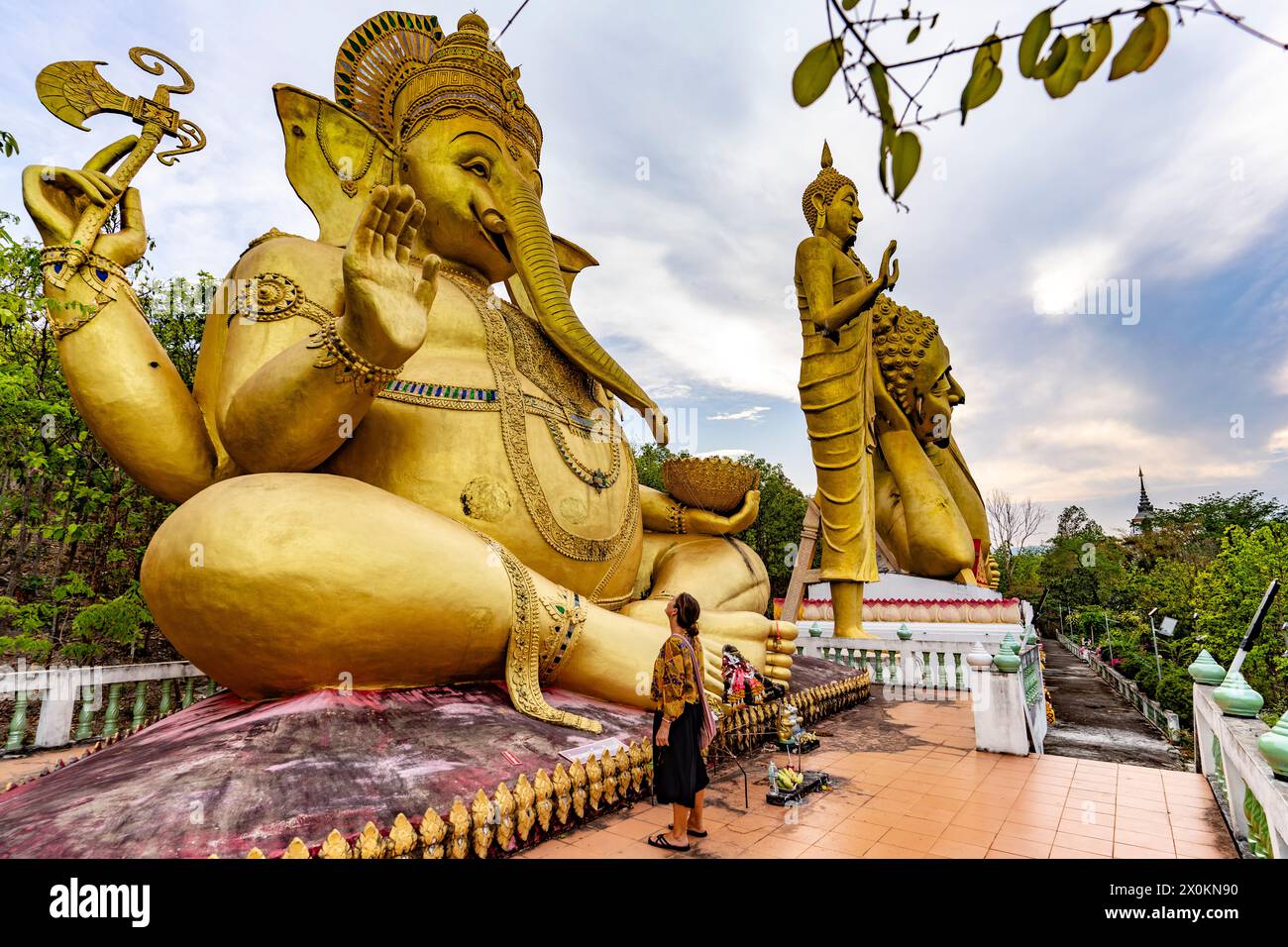 Tourist in front of the huge golden Ganesha statue of the Buddhist ...