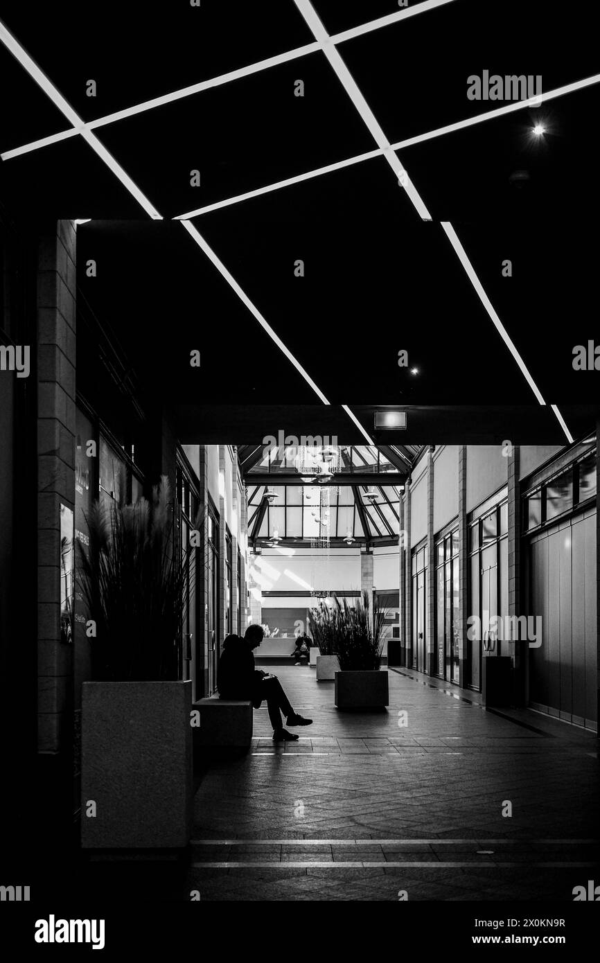 Shopping arcade, man sitting on a bench Stock Photo - Alamy Shopping arcade, man sitting on a bench Stock Photo - Alamy