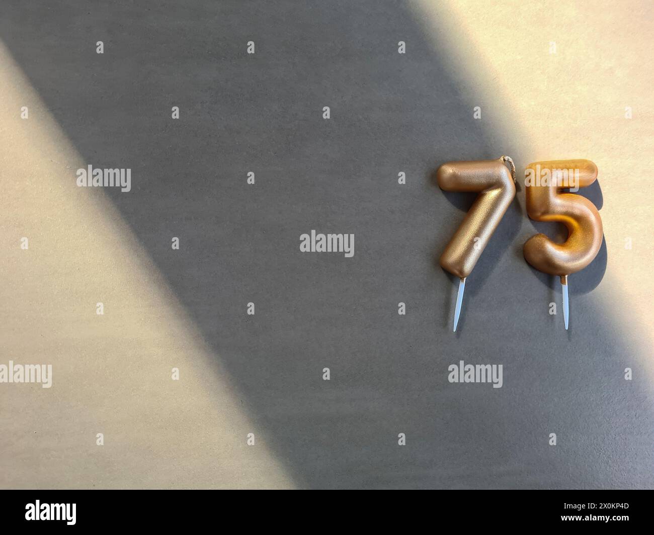 The number 75 as birthday and anniversary candles in sunlight with ...