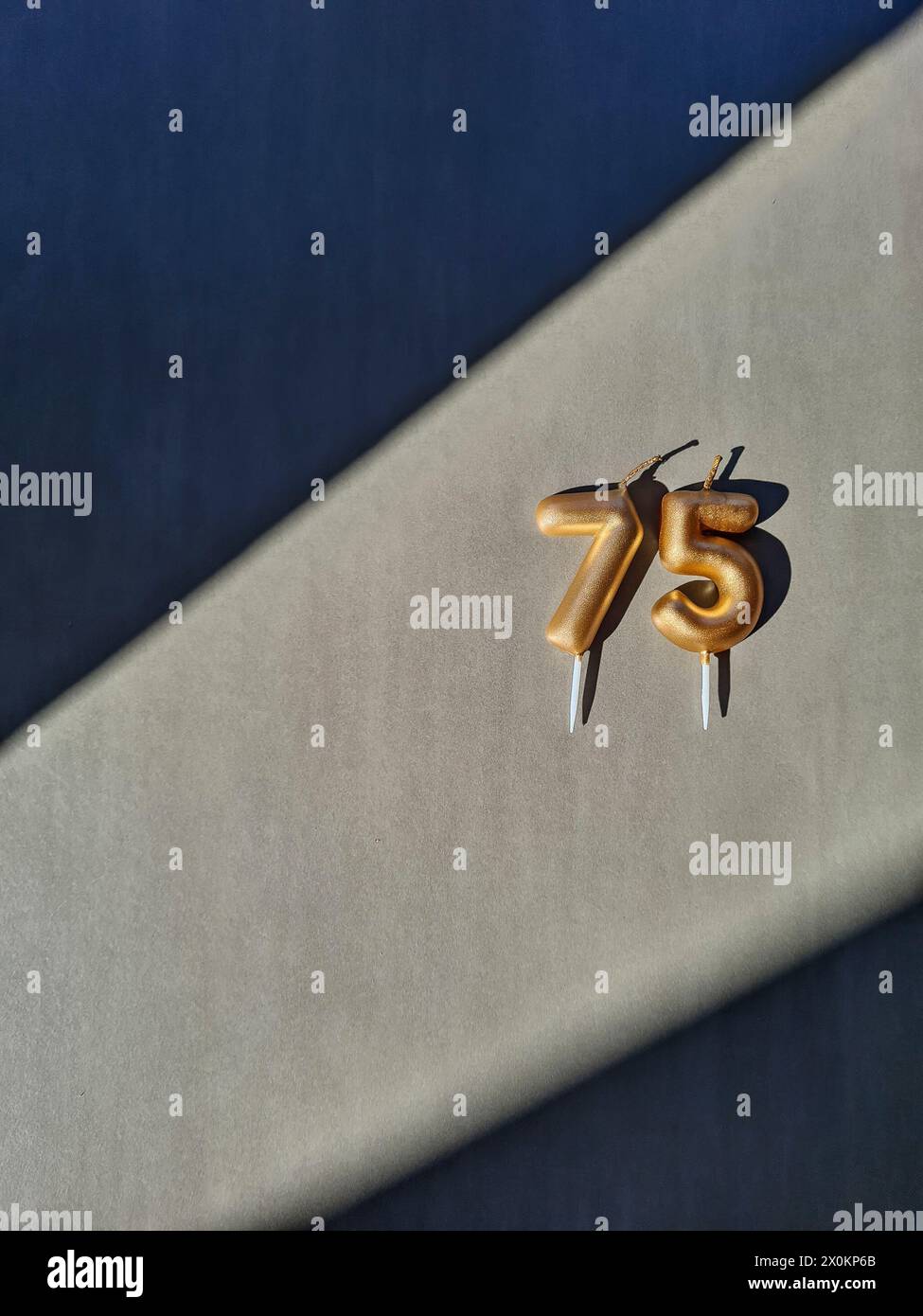 The number 75 as birthday and anniversary candles in sunlight with ...