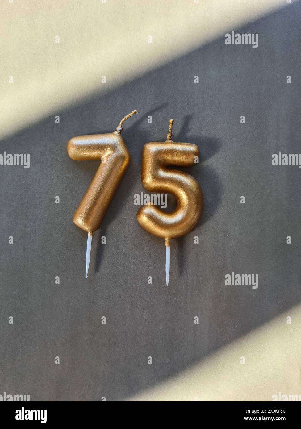 The number 75 as birthday and anniversary candles in sunlight with ...